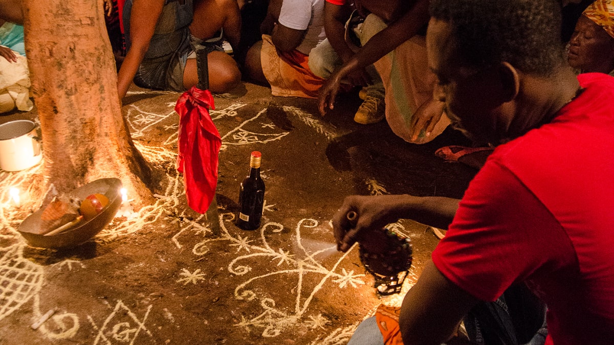 At a Voudou ceremony near Cyvadier Bay, practitioners pray and sing ...